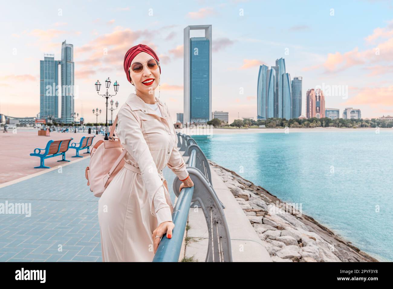 Amidst the bustling activity of Abu Dhabi's embankment, a young woman ...