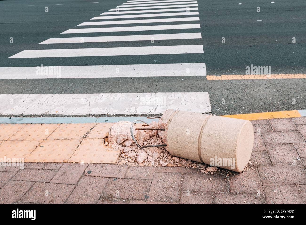 Car accident at pedestrian zebra crossing. Broken and crashed barrier ...