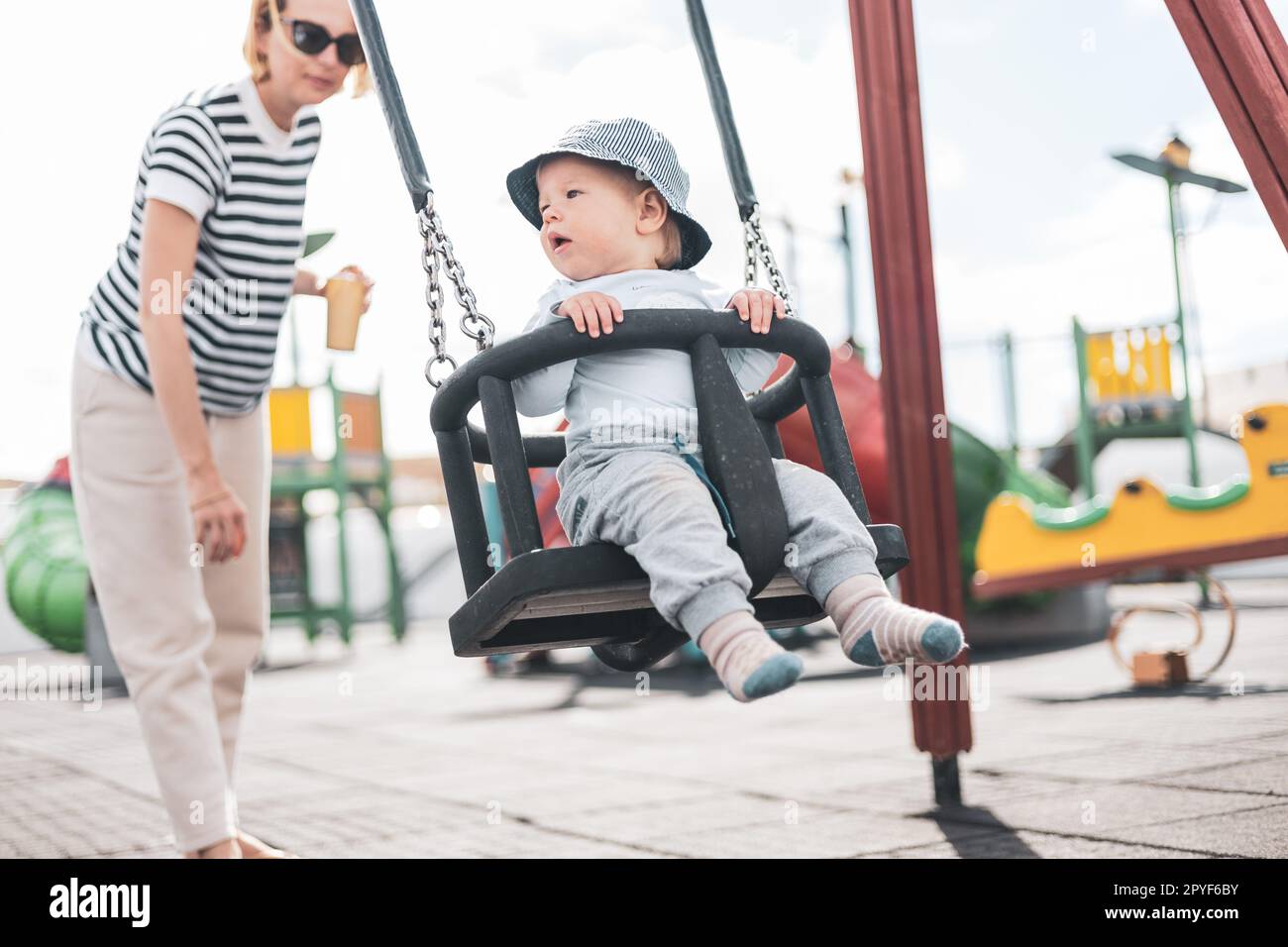 Child kid pushing swing hi-res stock photography and images - Alamy