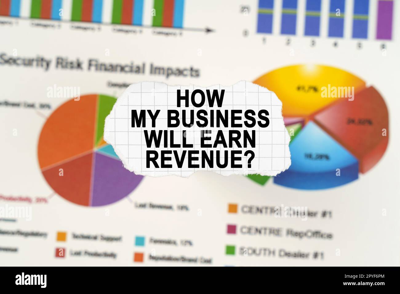 Business concept. On diagrams and graphs lies torn paper with the ...