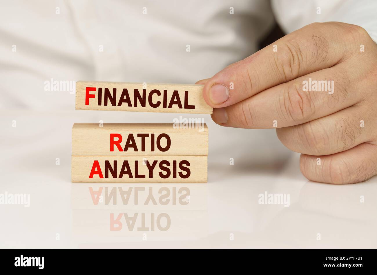 Business concept. In the hands of a person and on a reflective surface ...