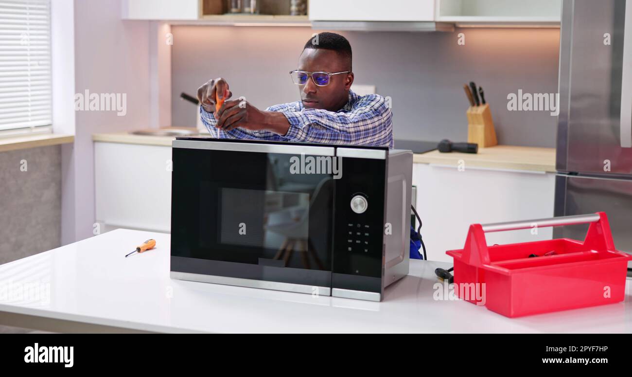 African man using screwdriver hi-res stock photography and images - Alamy