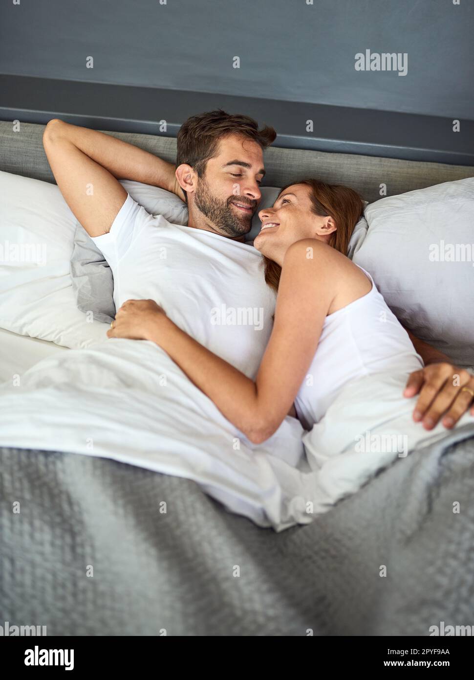 Couple hug bed hi-res stock photography and images - Alamy