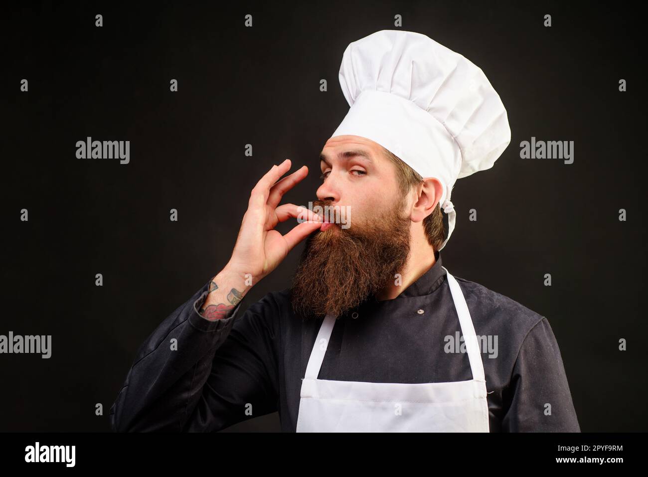 Chef man in uniform and white apron showing sign ok. Bearded cook in ...