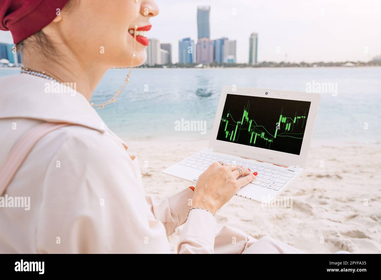Young woman working on laptop with stock market exchange and ...