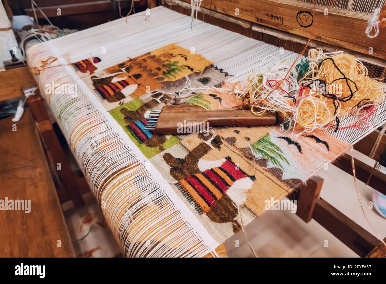 15 January 2023, Abu Dhabi, UAE: Weaving carpets with camel patterns in ...