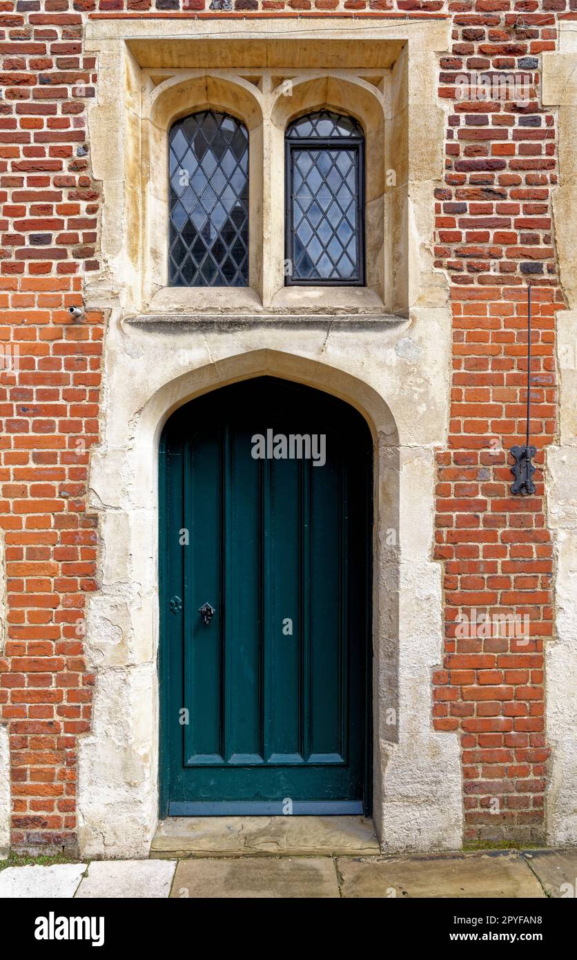 Arched rustic wooden door in a stone wall at Hampton Court Palace ...