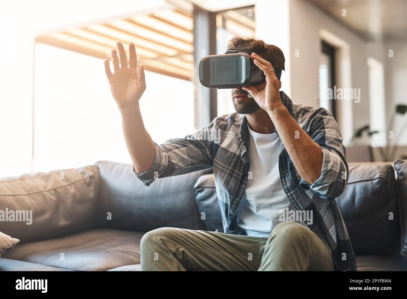 Right where the action is. a young man using a virtual reality headset ...