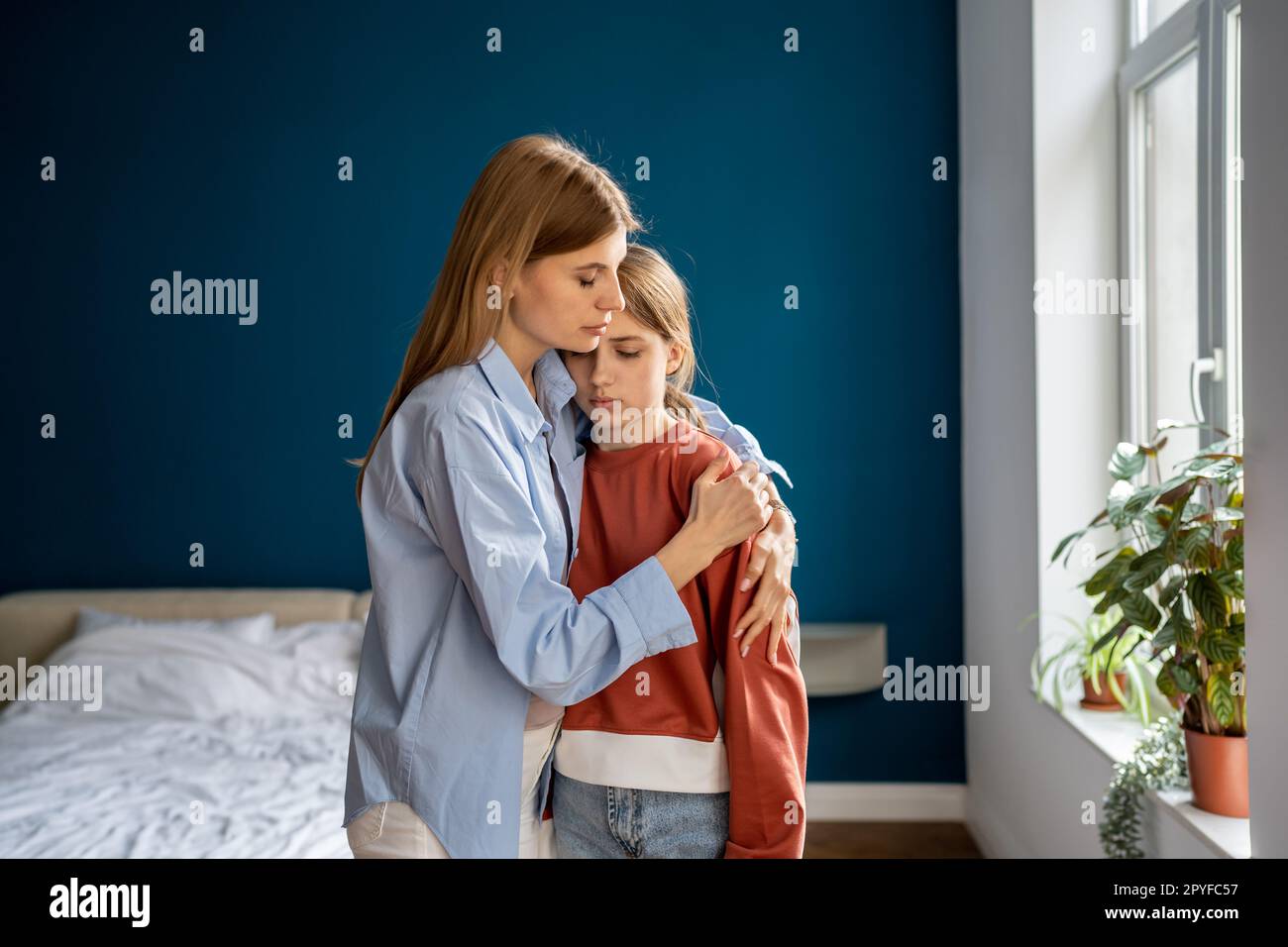 Affectionate empathic young mom tender embracing calming sad upset teen ...