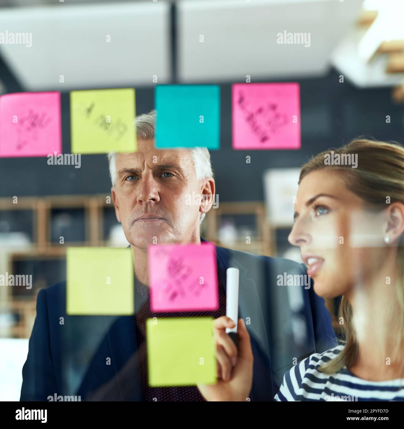 Taking the holistic approach to business strategizing. two colleagues having a brainstorming ...