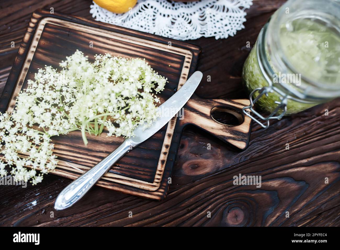 Grinding lemon and black elderberry on a cutting board to make an ...
