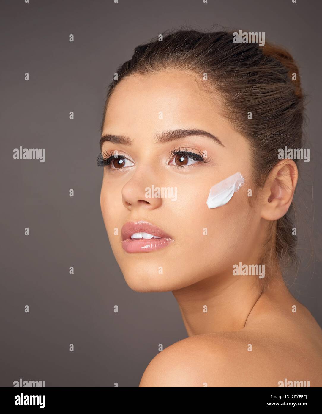 Your skin deserves to be pampered. a youthful model applying ...