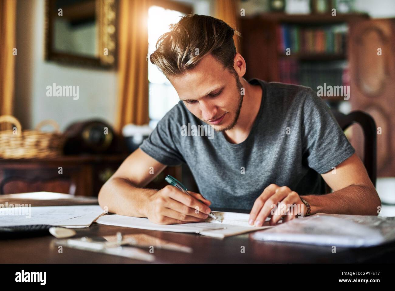 Putting his creativity to work. a young man working on a project at ...