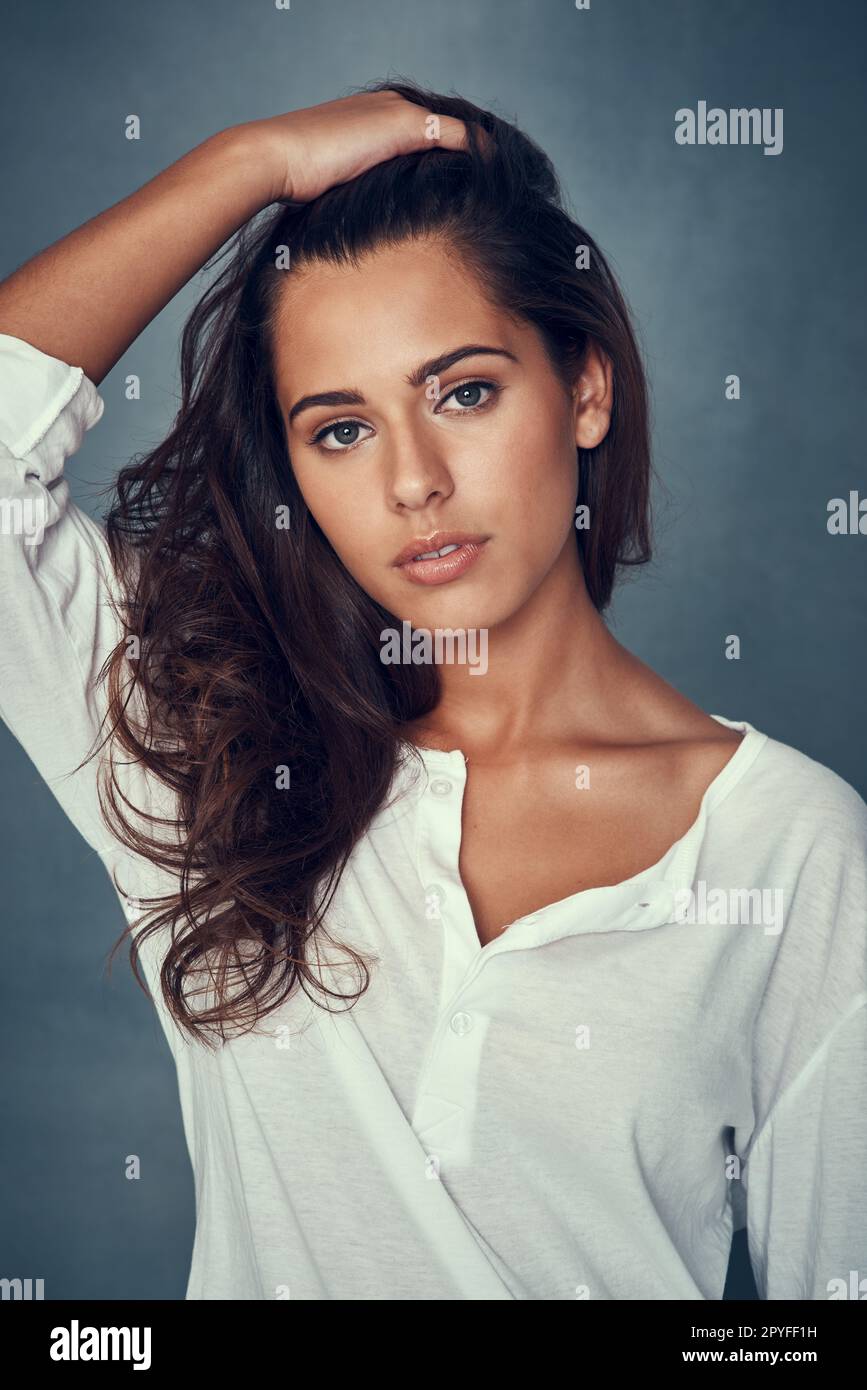 Hair so soft you just have to touch it. Portrait of a beautiful young ...