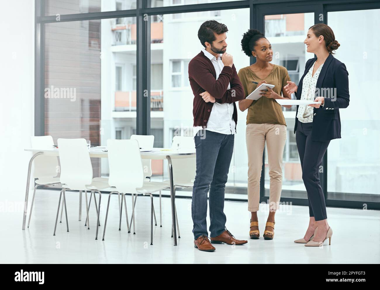Running through their tasks for the day. a group of colleagues having a ...