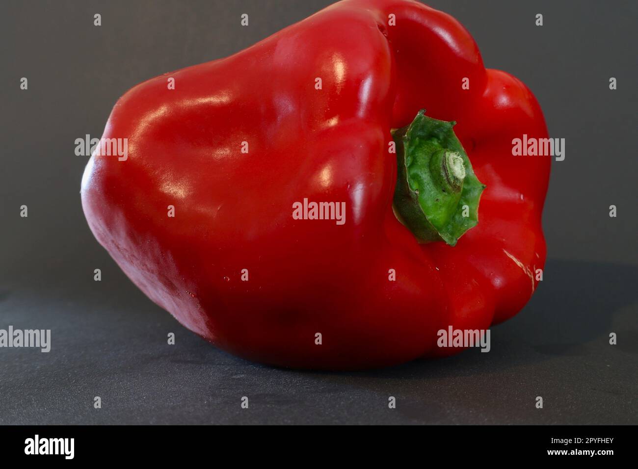 Giant Red Bell Pepper on a Black Background Stock Photo - Alamy