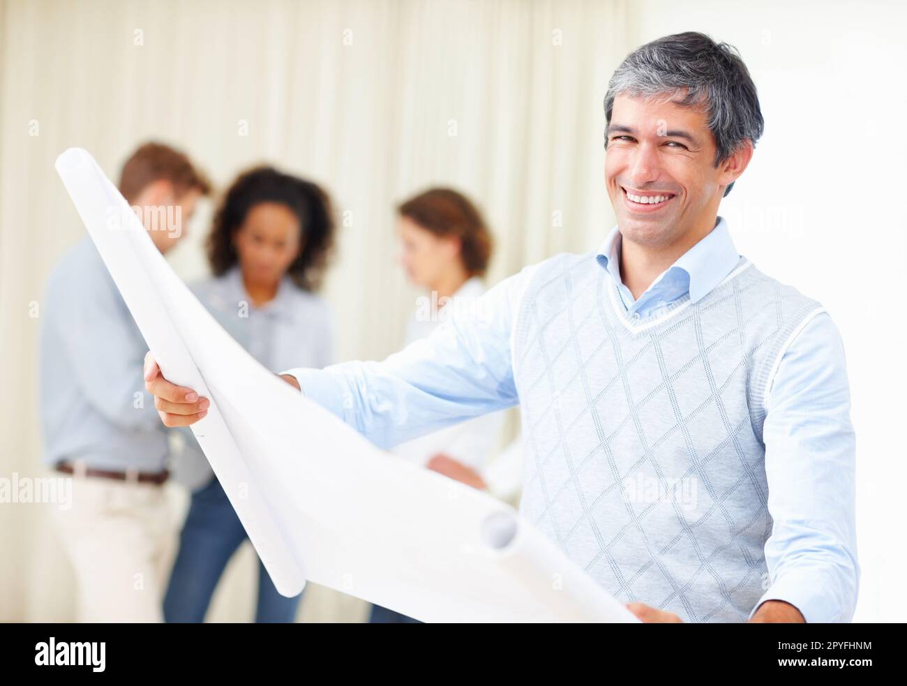 Business man going through blueprint. Smiling business man reading ...