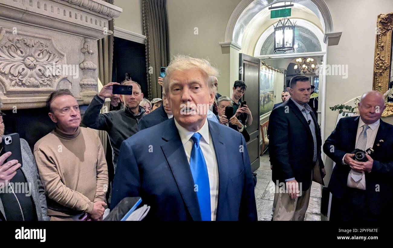 Former US president Donald Trump speaks to reporters as he arrives at ...