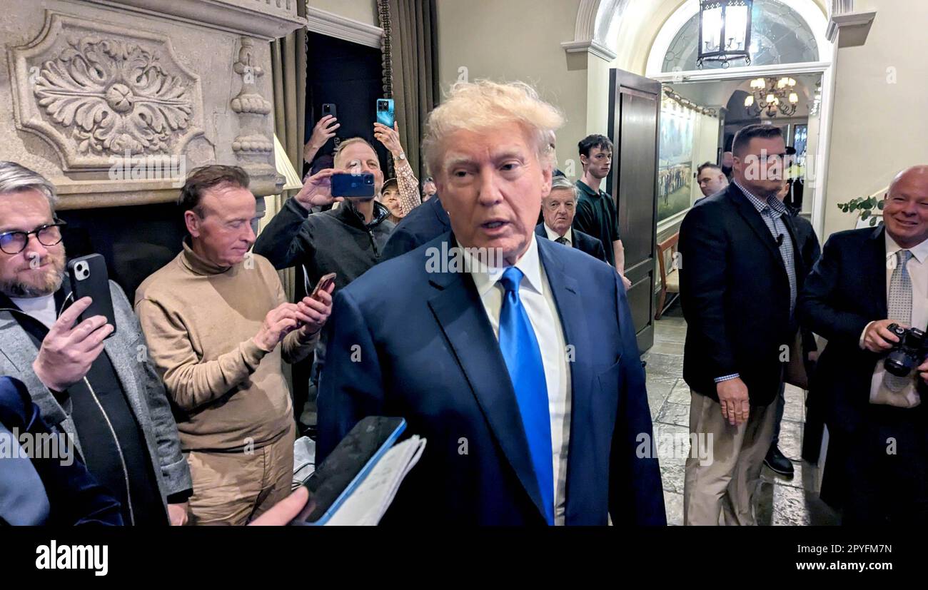 Former US president Donald Trump speaks to reporters as he arrives at ...