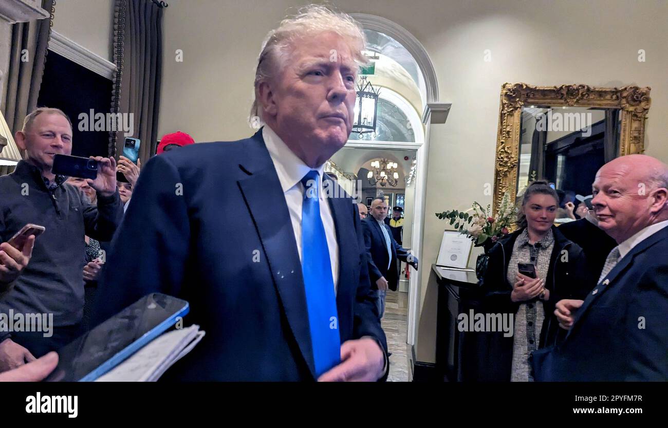Former US president Donald Trump speaks to reporters as he arrives at ...