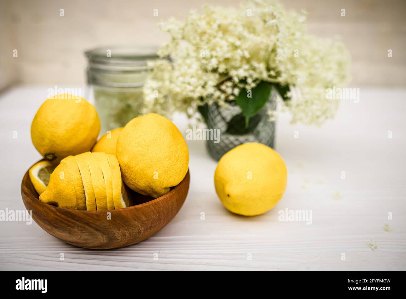 wooden plate with fresh lemons for a healthy refreshing non-alcoholic ...