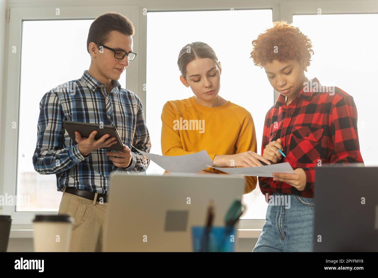 Teamwork brainstorm young professional team concept. Happy multiracial coworkers cooperating ...