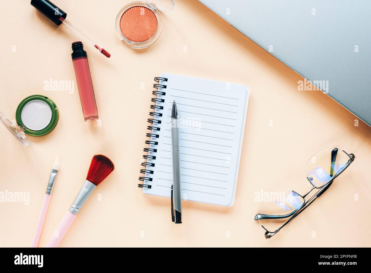 Blank notepad with pen, glasses, notebook and makeup cosmetics on ...