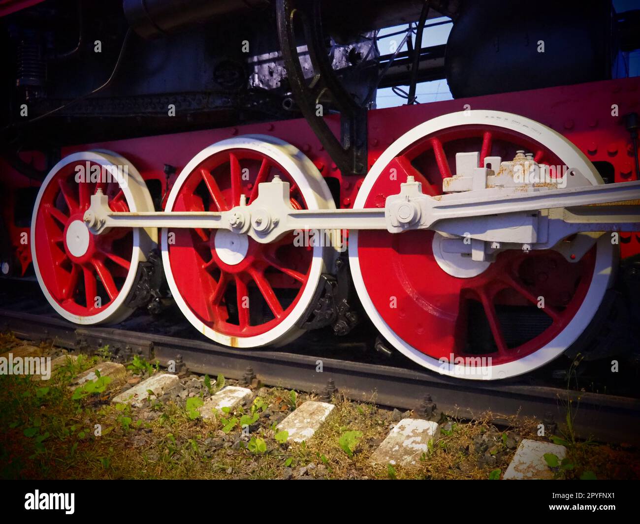 Retro vintage wheels of a locomotive or train close up. Red large heavy ...