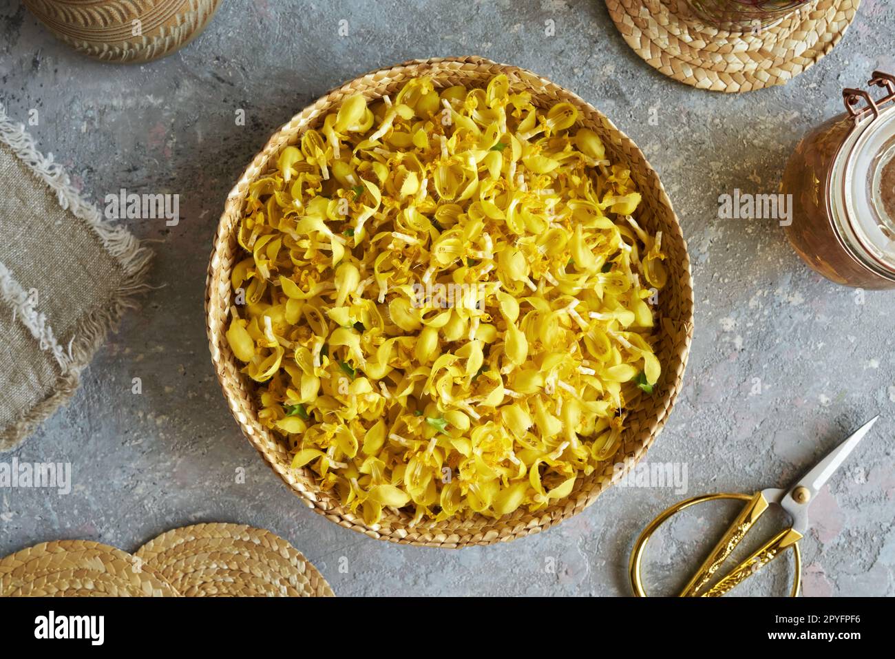 Fresh yellow dead-nettle flowers in a wicker basket on a table. Herbal ...