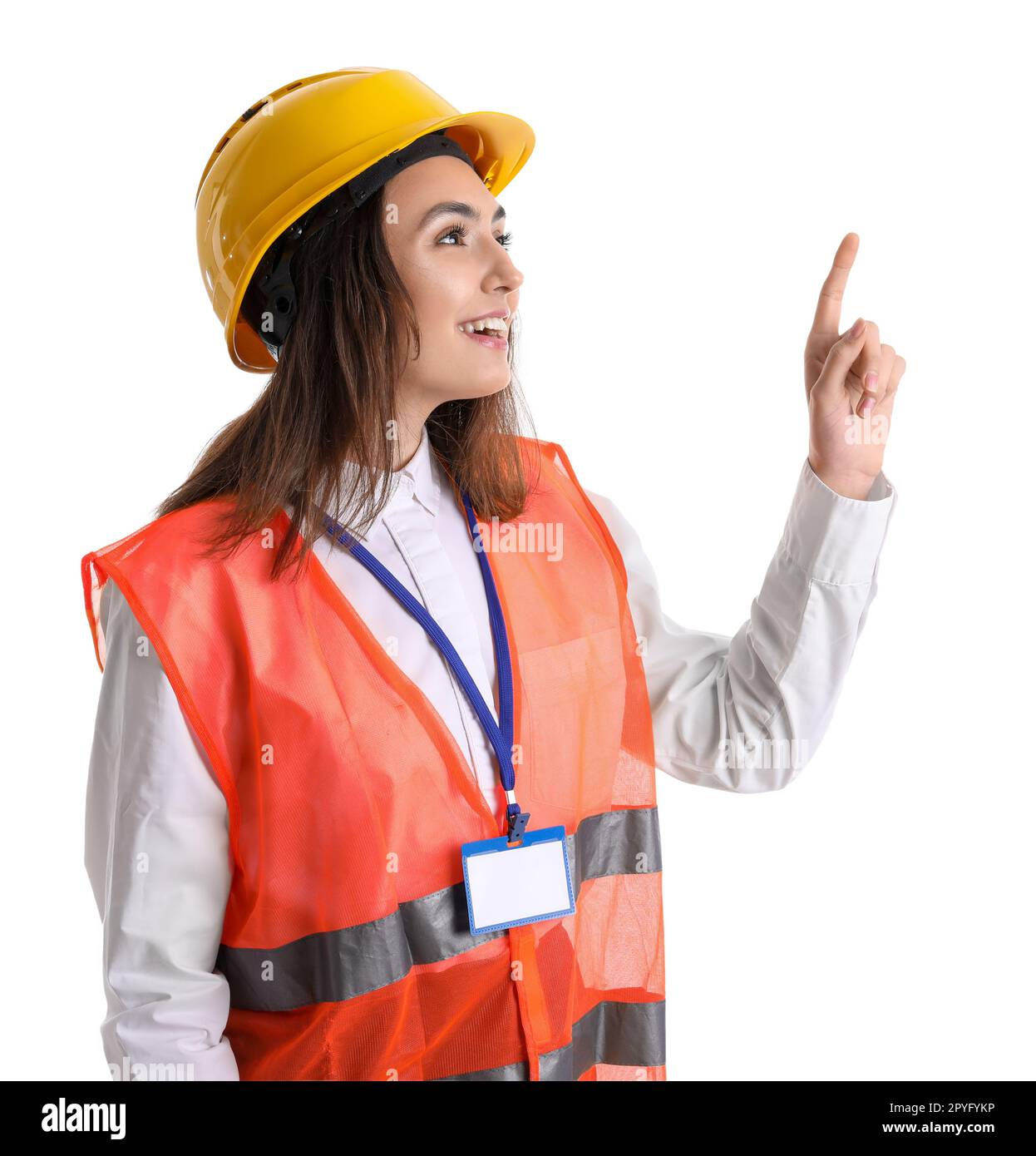 Female worker in vest and hardhat pointing at something on white ...