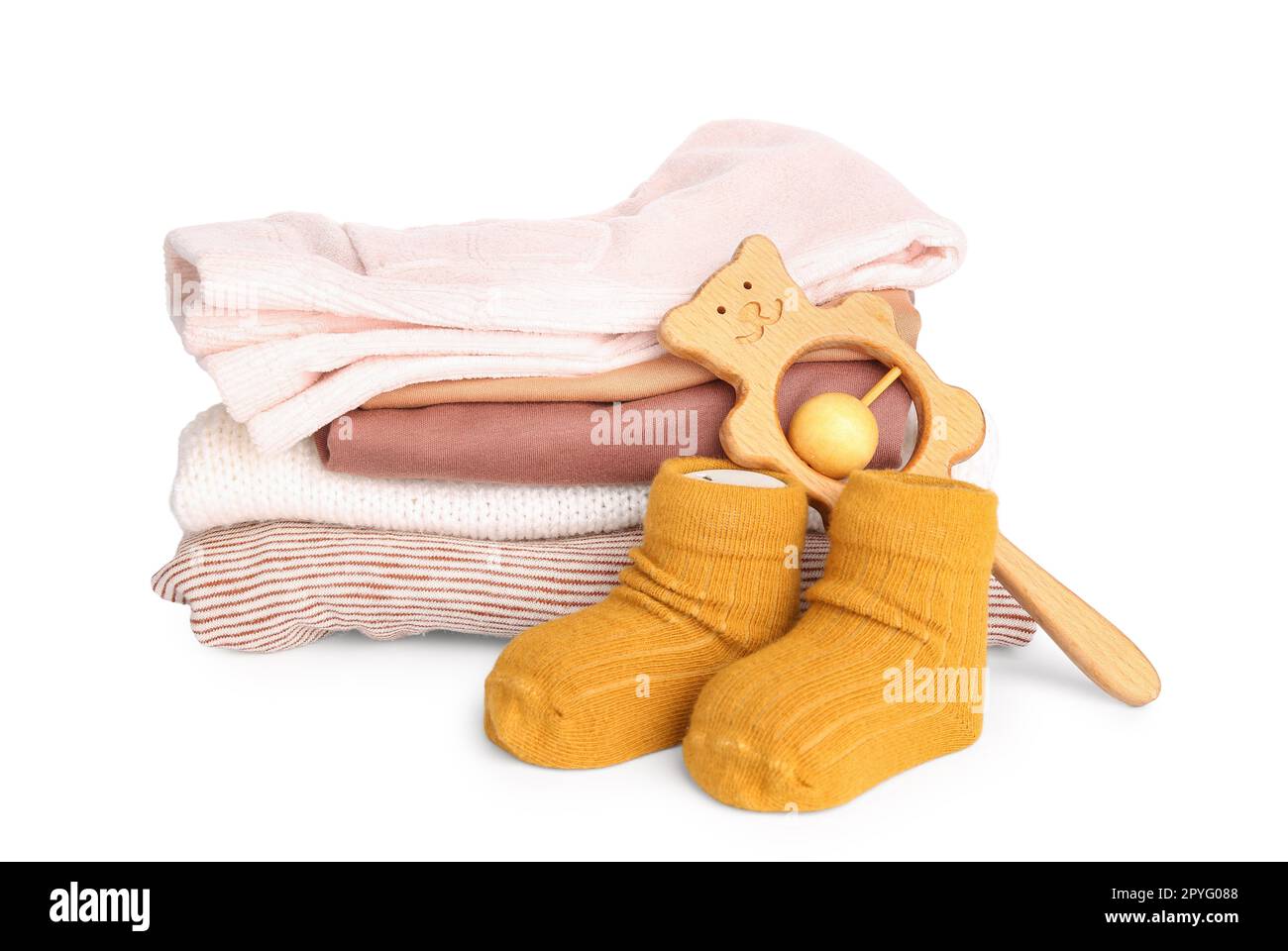 Stack of baby clothes, socks and wooden toy on white background Stock ...