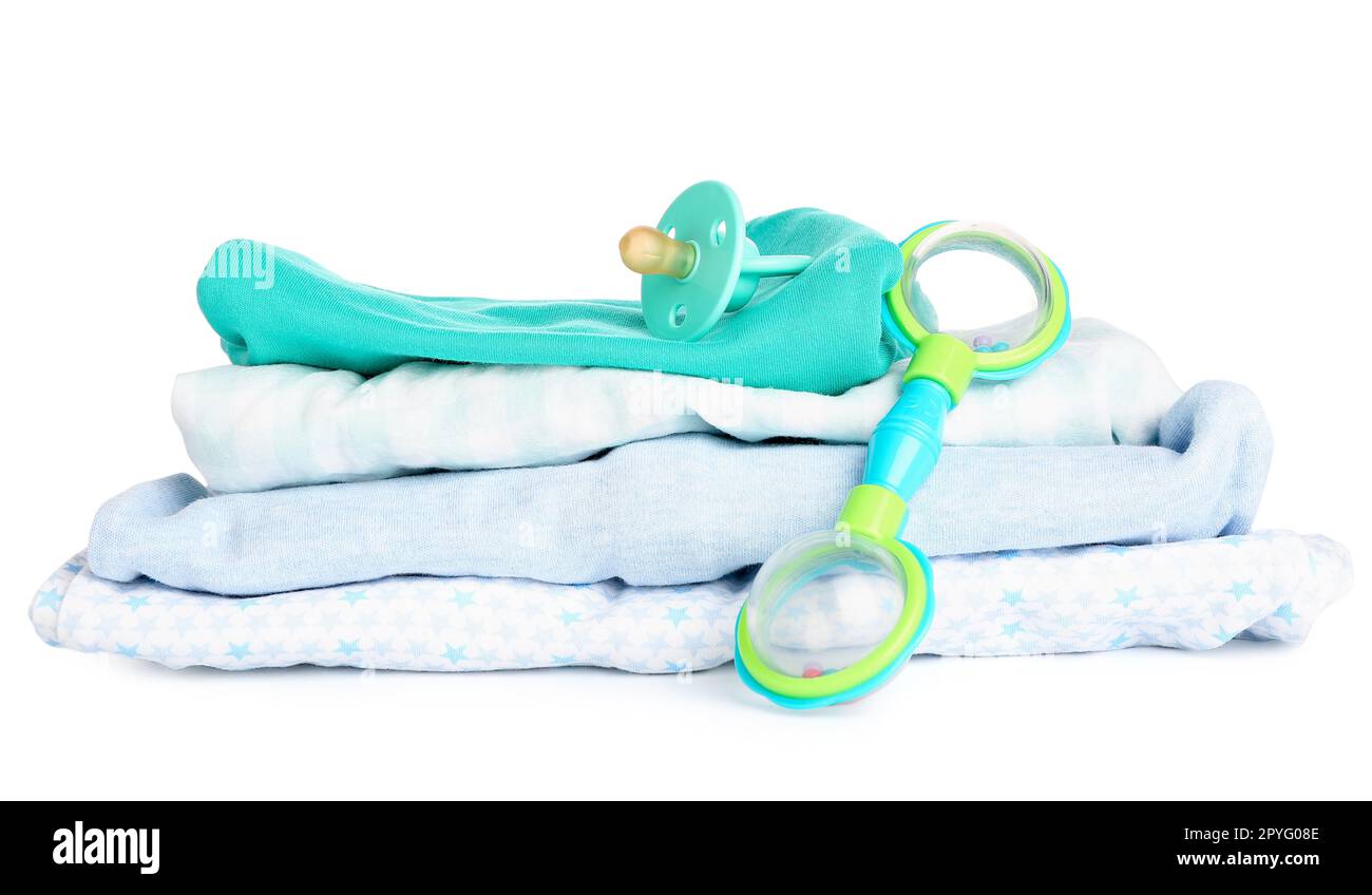 Stack of baby clothes, toy and pacifier on white background Stock Photo ...