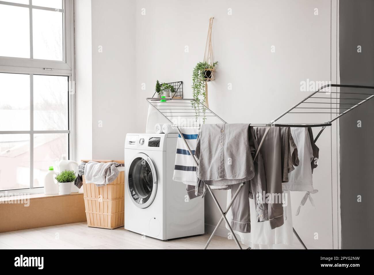 Interior of laundry room with washing machine, basket and dryer Stock ...