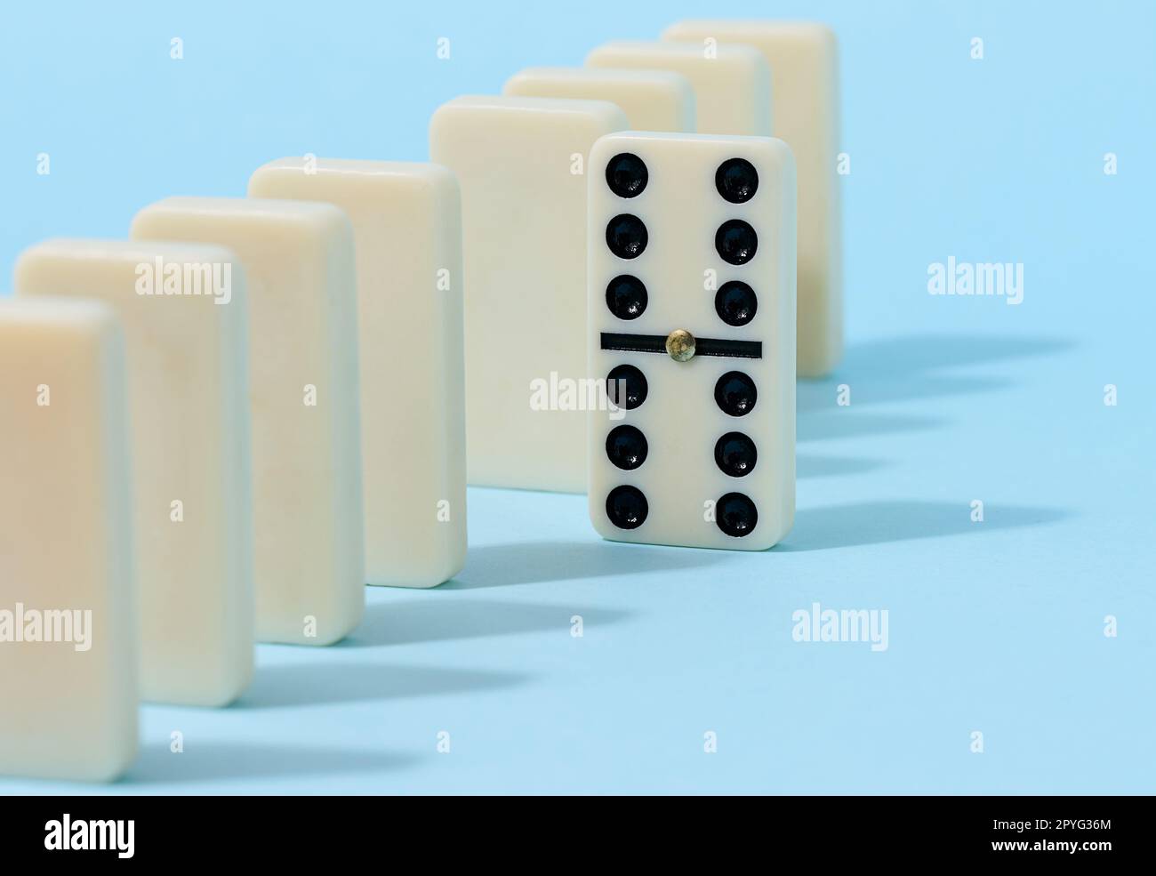 A stack of dominoes on a blue background, an intellectual game Stock ...