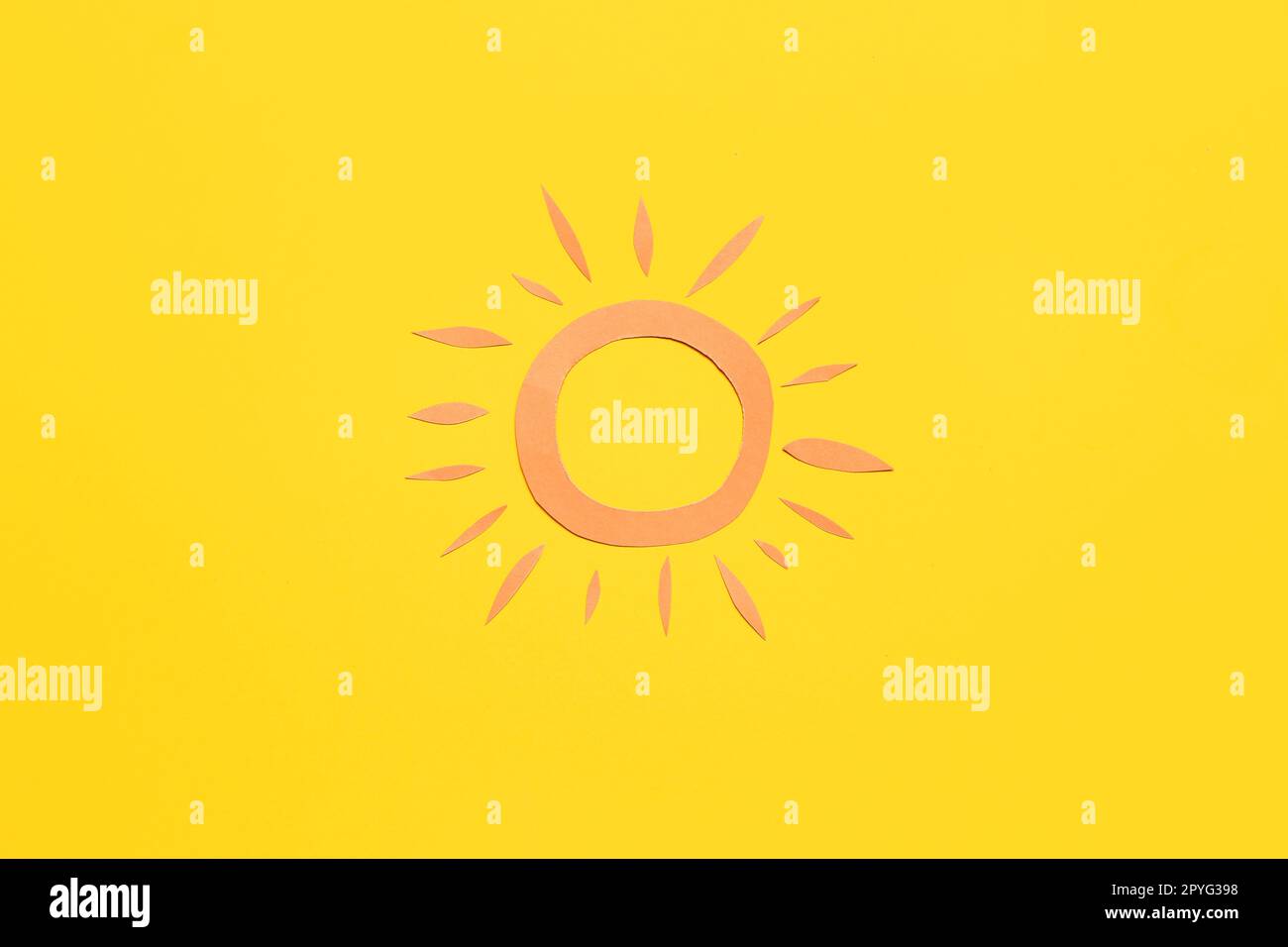 Paper sun on yellow background Stock Photo - Alamy