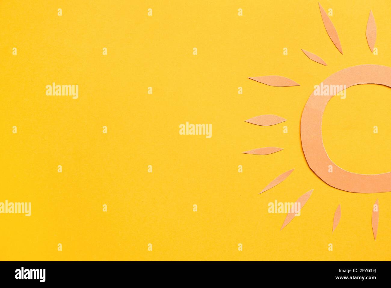 Paper sun on yellow background Stock Photo - Alamy