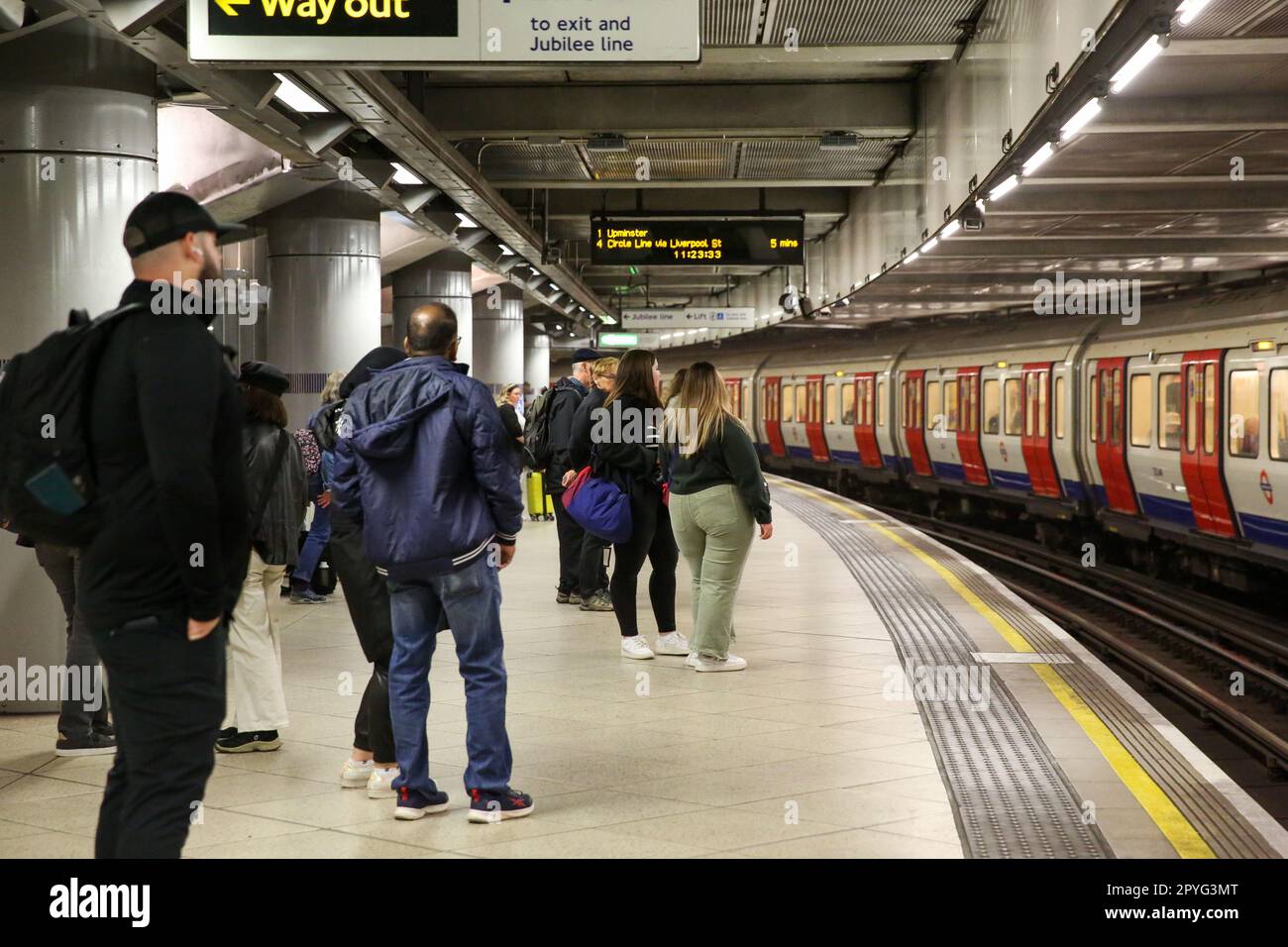 Passengers on Westminster underground station platform wait for a train ...
