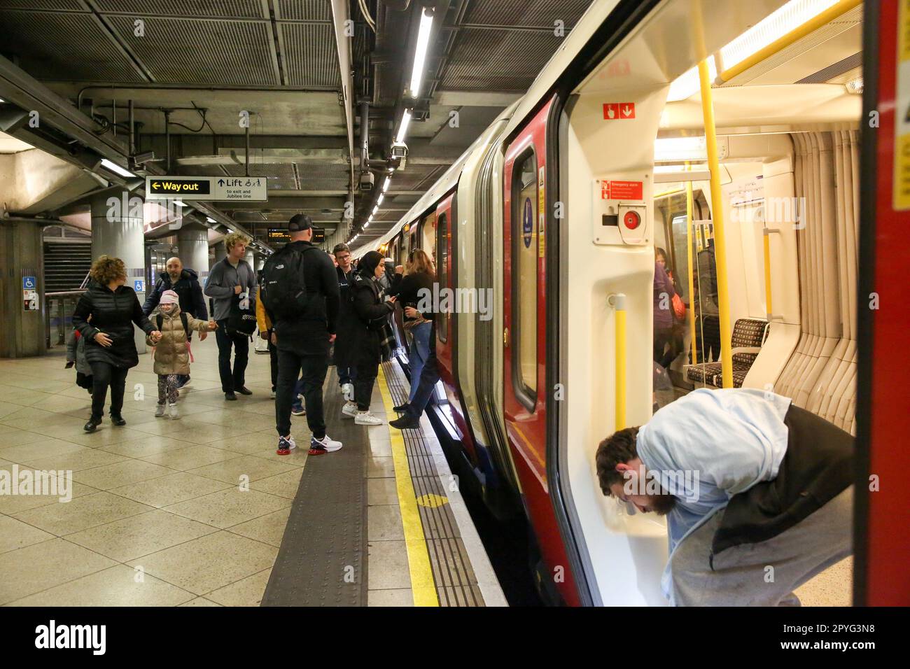Passengers board a train at Westminster underground station Stock Photo ...