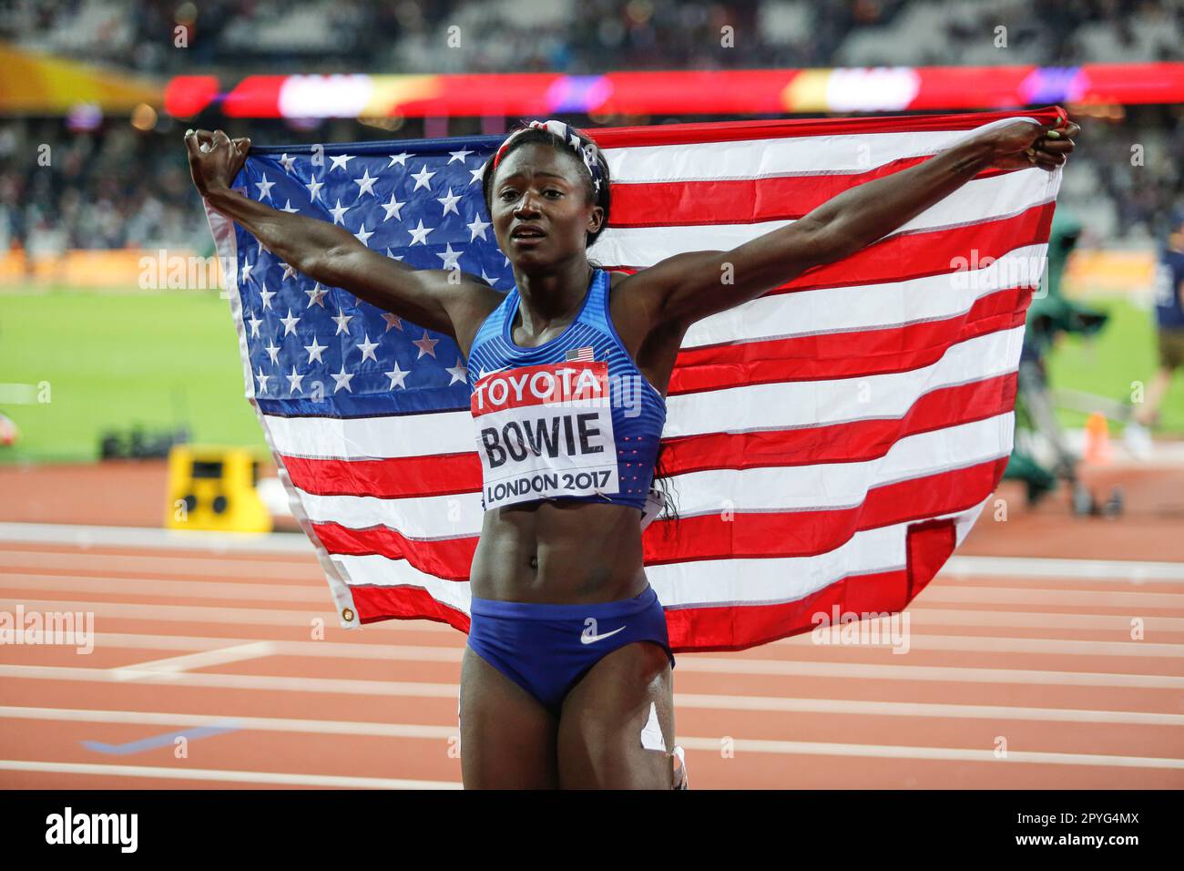 Tori Bowie with the USA flag after winning the 100m at the World Athletics Championships in ...