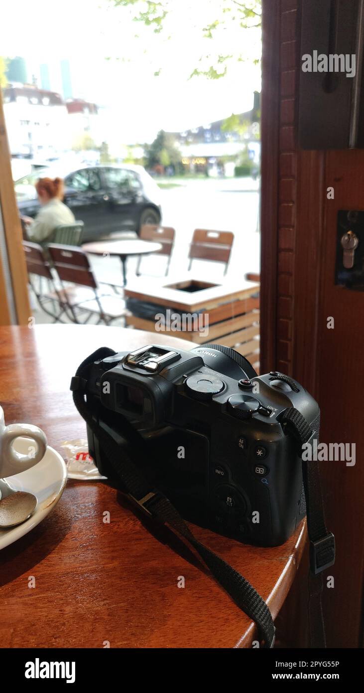 A DSLR camera placed on a dining room table Stock Photo - Alamy