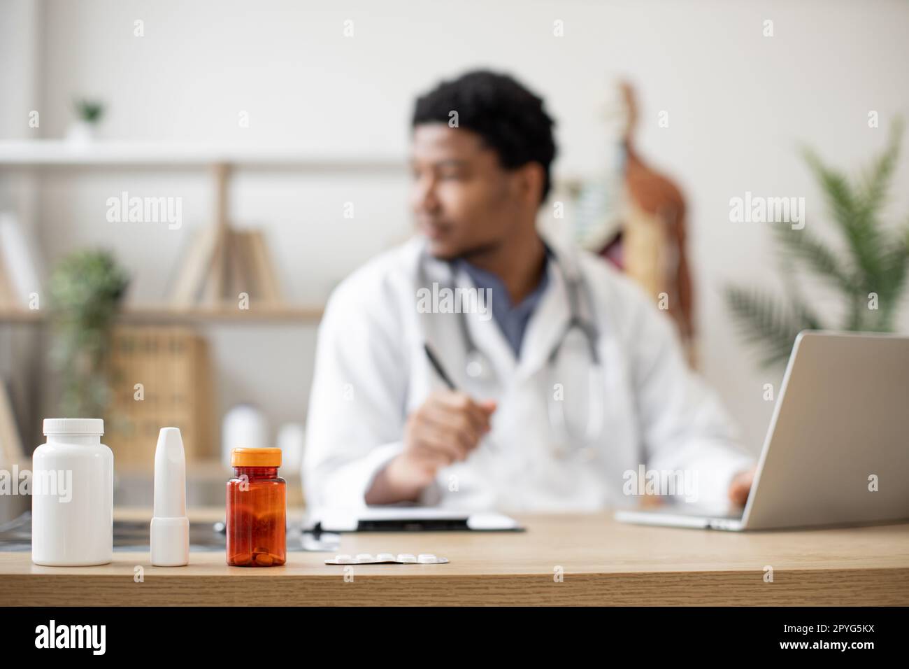 busy doctor with laptop computer and clipboard Stock Photo - Alamy