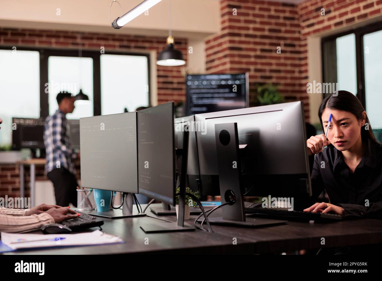 Pensive Asian Tech Enginner Working On Code Development And Brainstorming Ideas To Create Html
