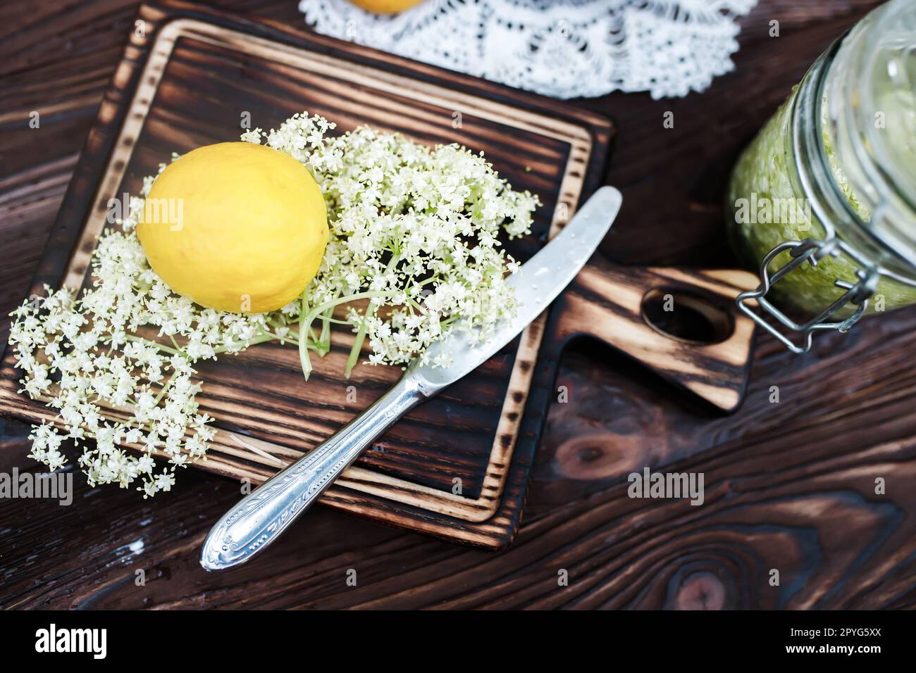 Grinding lemon and black elderberry on a cutting board to make an ...