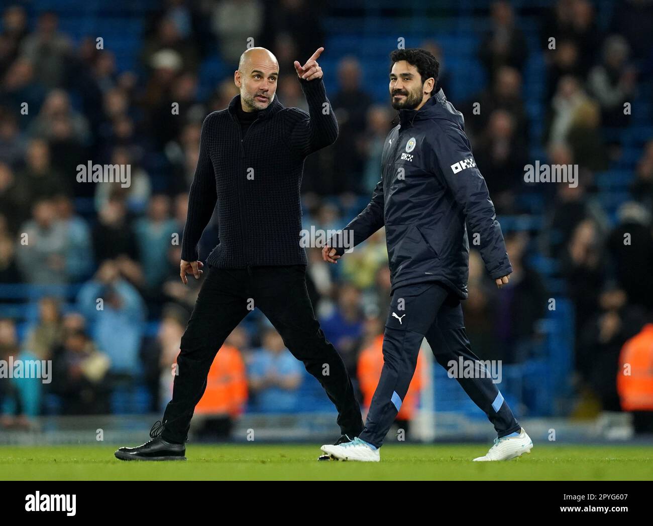 Manchester City manager Pep Guardiola speaks with Ilkay Gundogan after ...