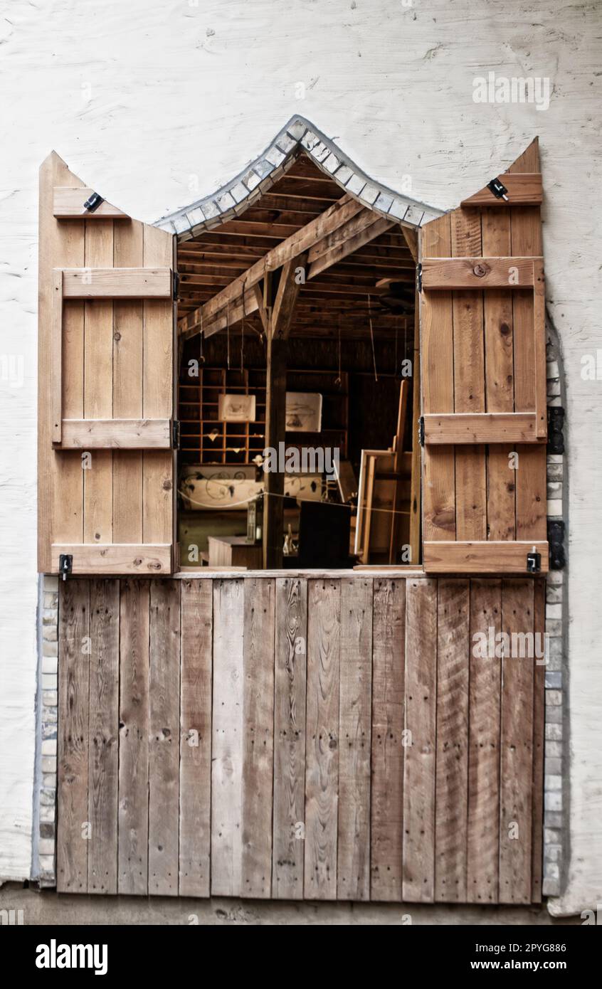 Rustic medival dutch half or split door in paster wall with dark artist ...