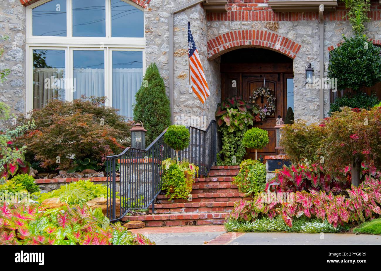 American flag front of house hi-res stock photography and images - Alamy