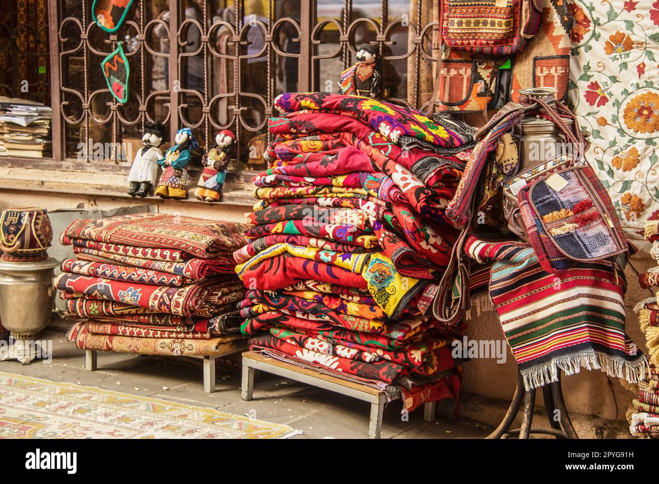 Piles of rugs and suzani-embroidered & decorative tribal textiles - and ...