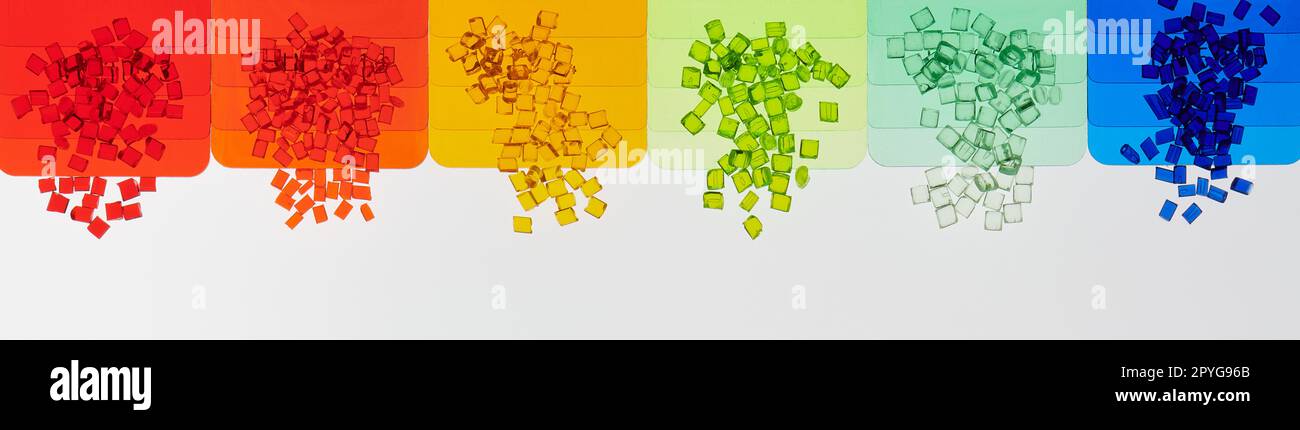 colored transparent plastic resin granulates with its color samples ...