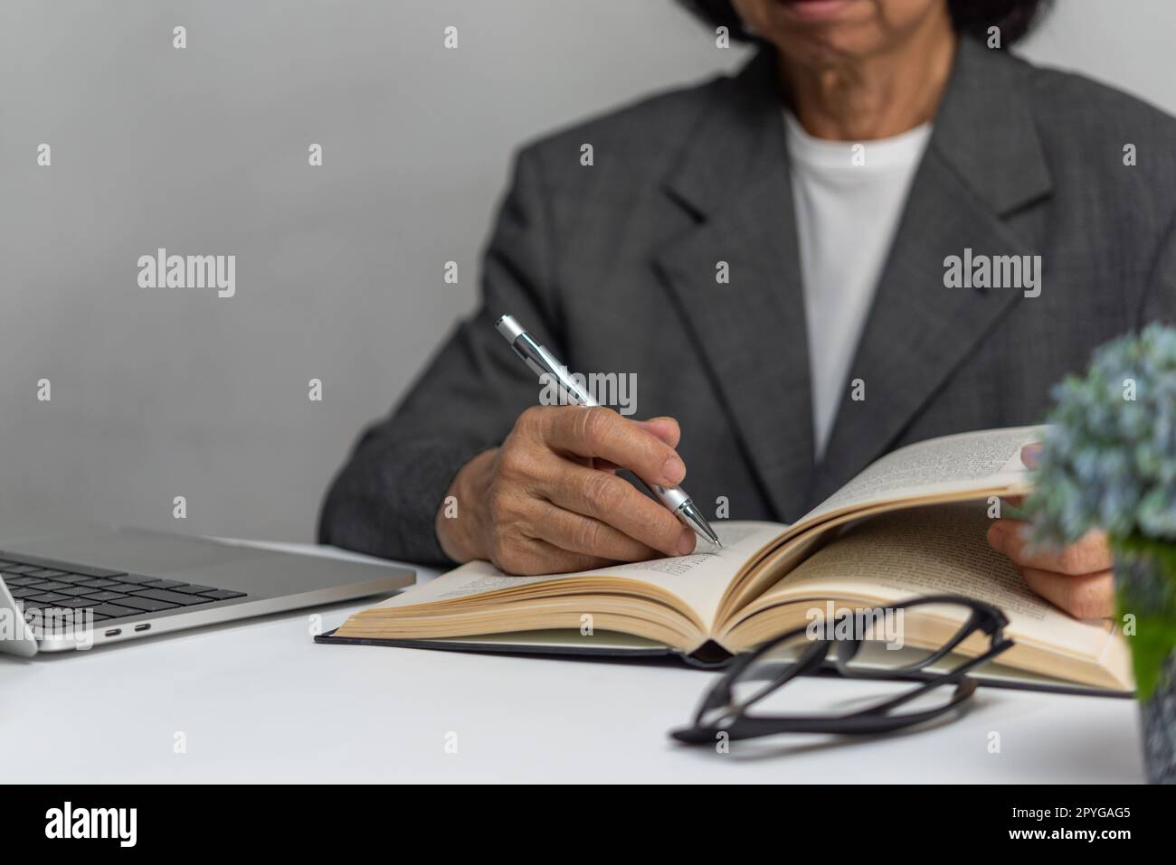 Woman hands with pen writing on notebook in the office.learning ...