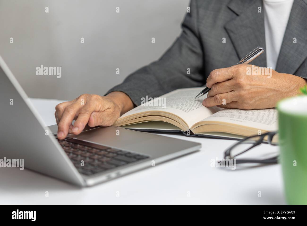 Woman hands with pen writing on notebook in the office.learning ...